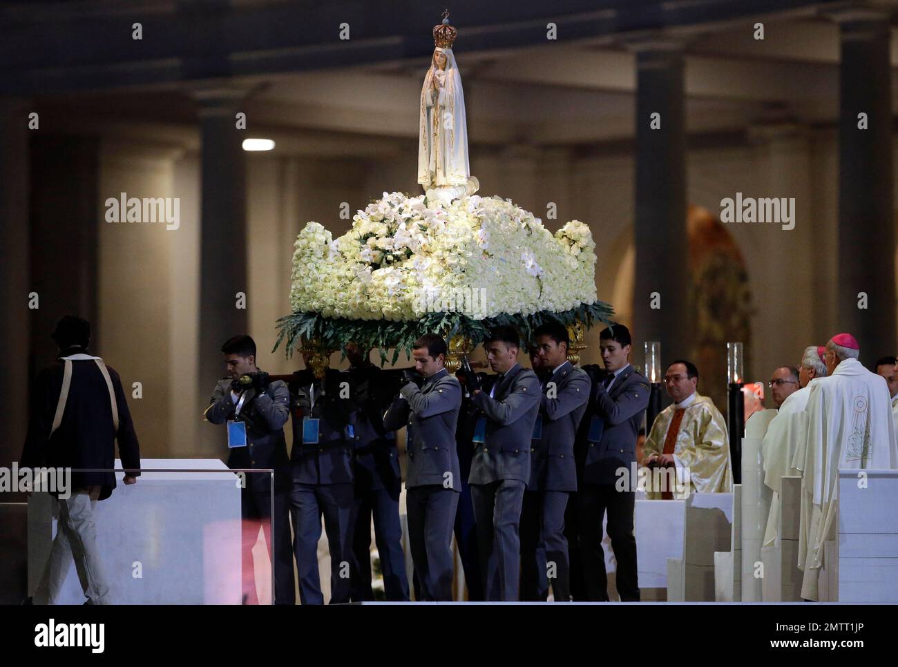The statue of Our Lady of Fatima is carried through the crowd of ...