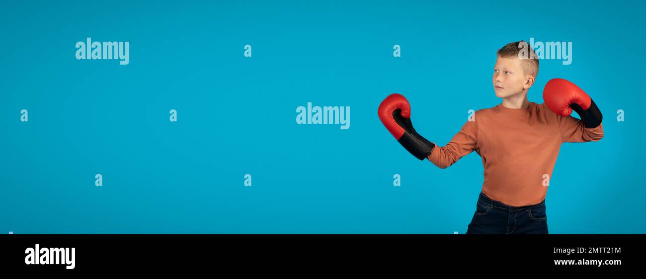 Preteen Boy Wearing Boxing Gloves Making Fighter Posture And Looking ...
