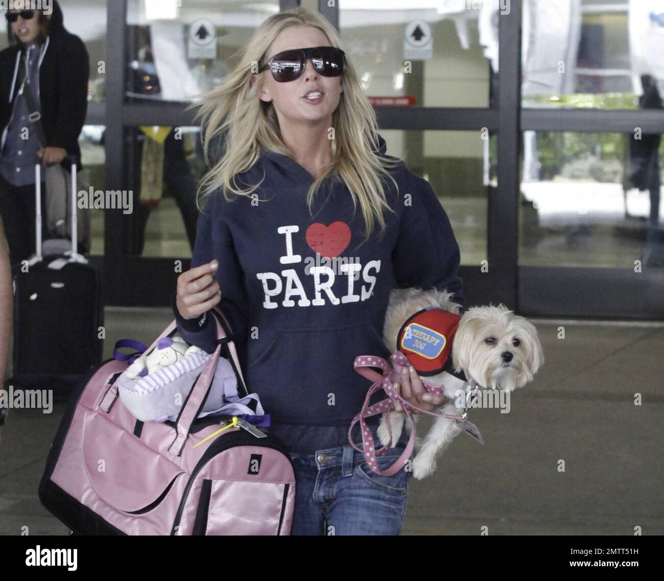 Tara Reid arriving at LAX airport with her pooch and unknown companion ...