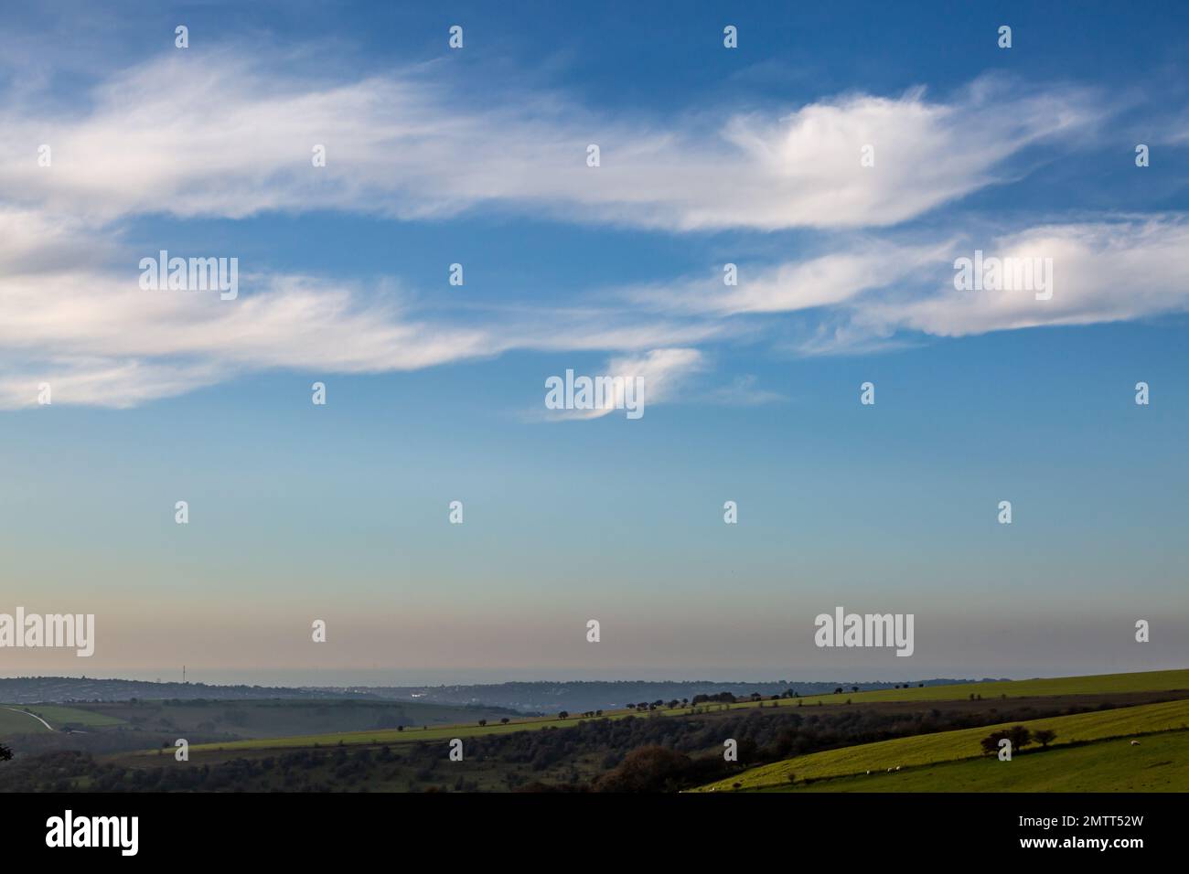 A view from Ditchling Beacon with a blue sky and wispy clouds overhead ...