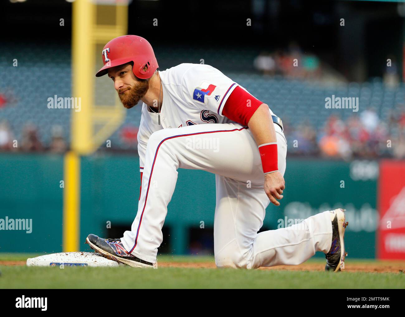Texas Rangers' Jonathan Lucroy gets back to first safely on a pick off ...