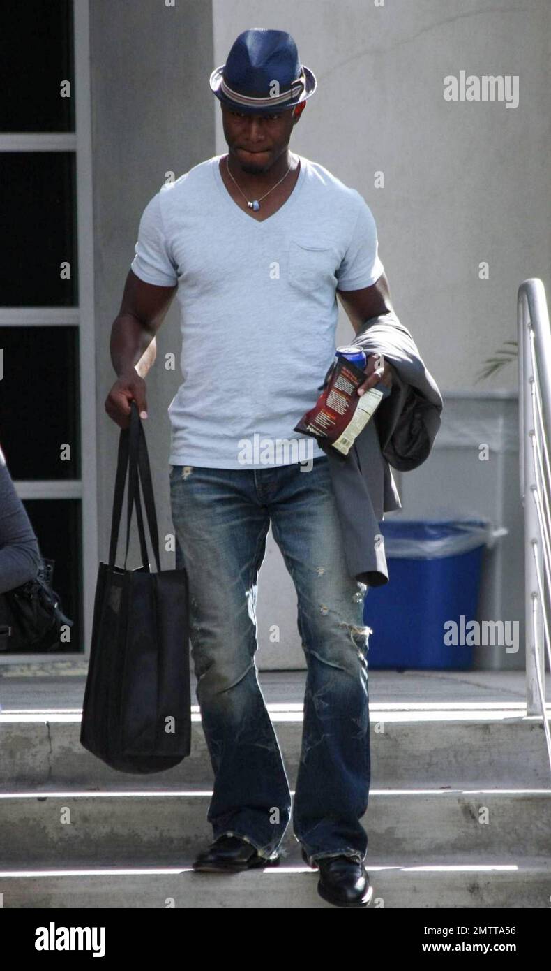 Taye Diggs carries along a soda and a snack as he leaves the "Chelsea ...