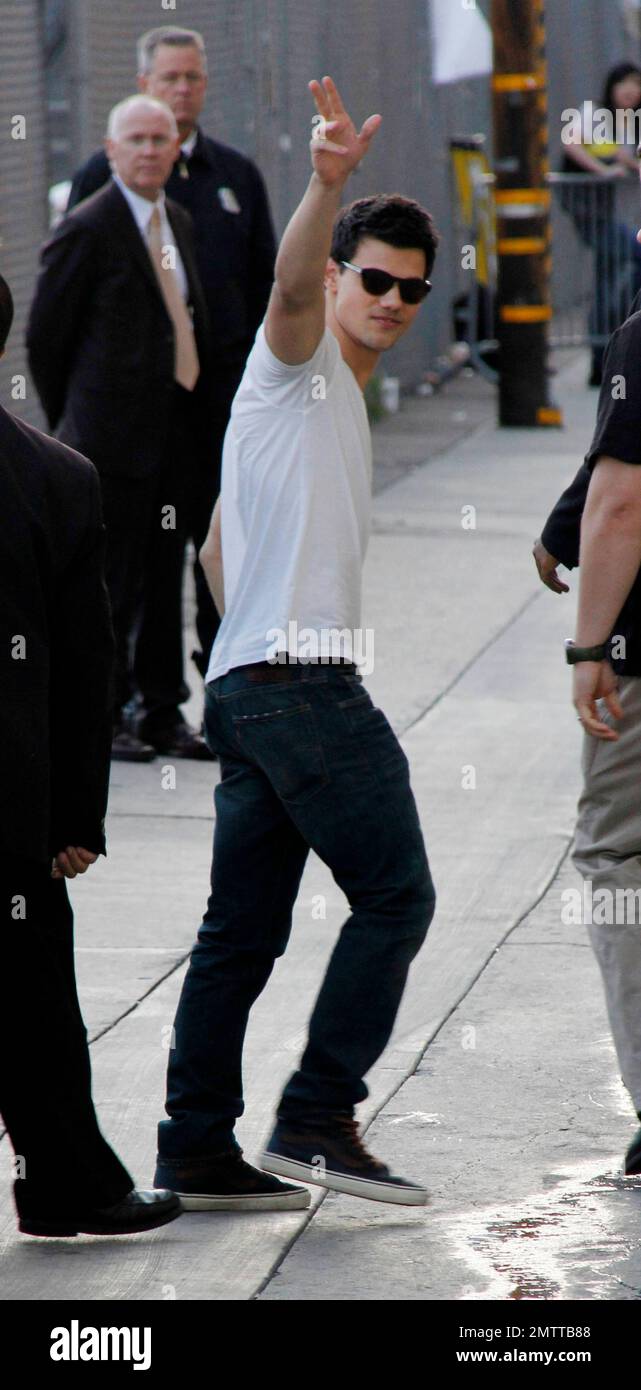 Taylor Lautner waves at fans as he leaves the Jimmy Kimmel Show. Los ...