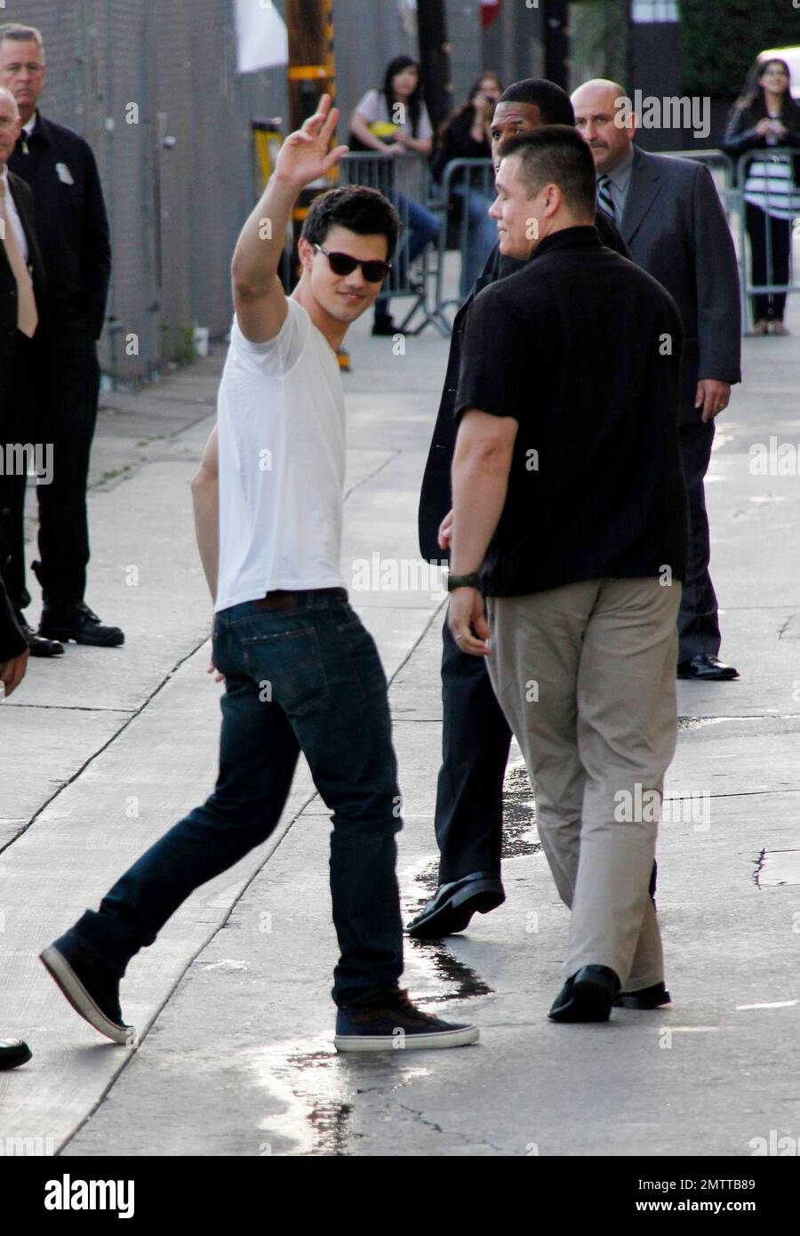 Taylor Lautner waves at fans as he leaves the Jimmy Kimmel Show. Los ...