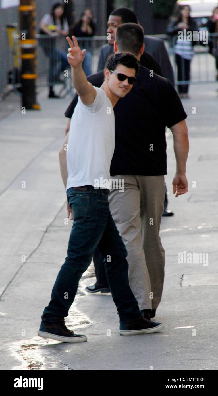 Taylor Lautner waves at fans as he leaves the Jimmy Kimmel Show. Los ...