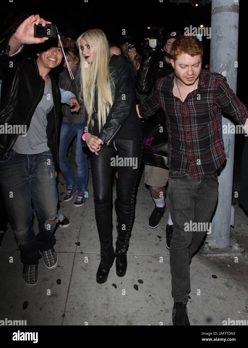 Wearing a black leather outfit, rocker and "Gossip Girl" star Taylor ...