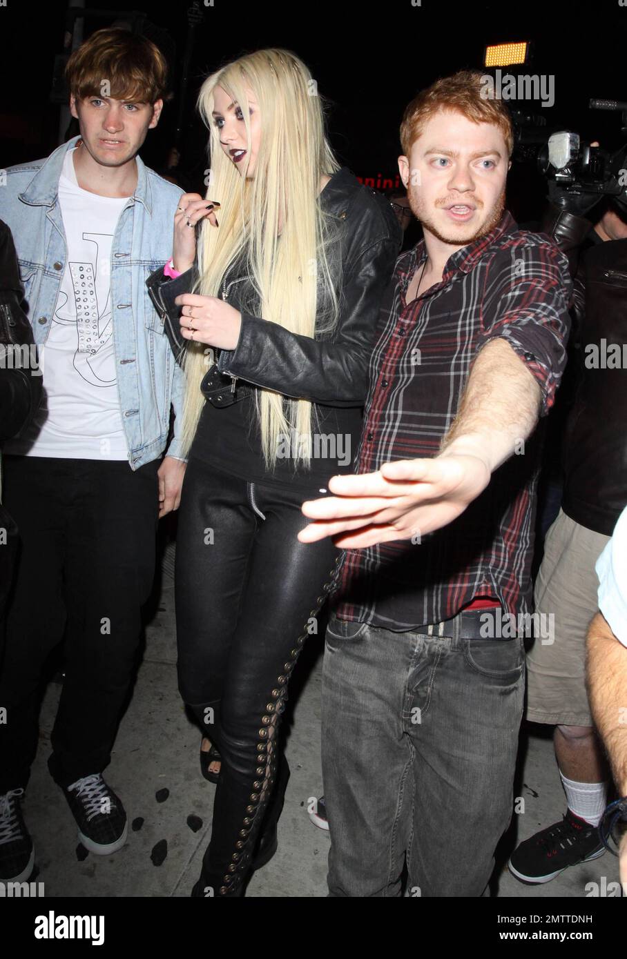 Wearing a black leather outfit, rocker and "Gossip Girl" star Taylor ...
