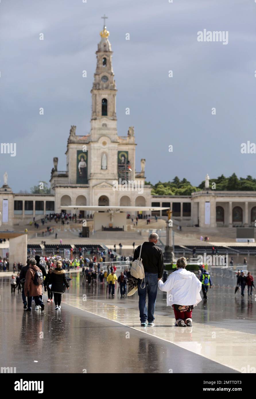 A woman walks on her knees paying penance at the Fatima Sanctuary ...