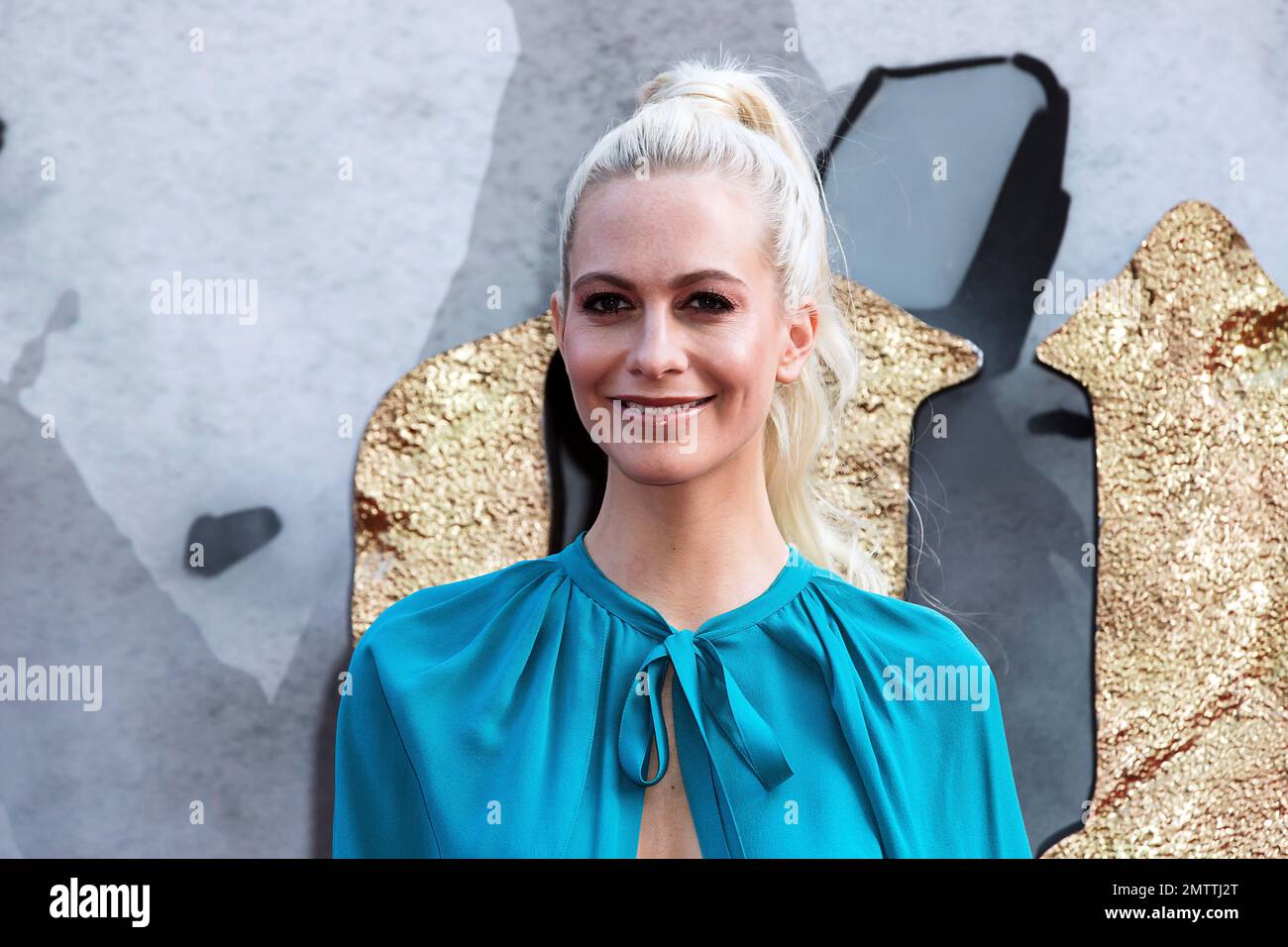 Actress Poppy Delevingne poses for photographers on arrival at the ...