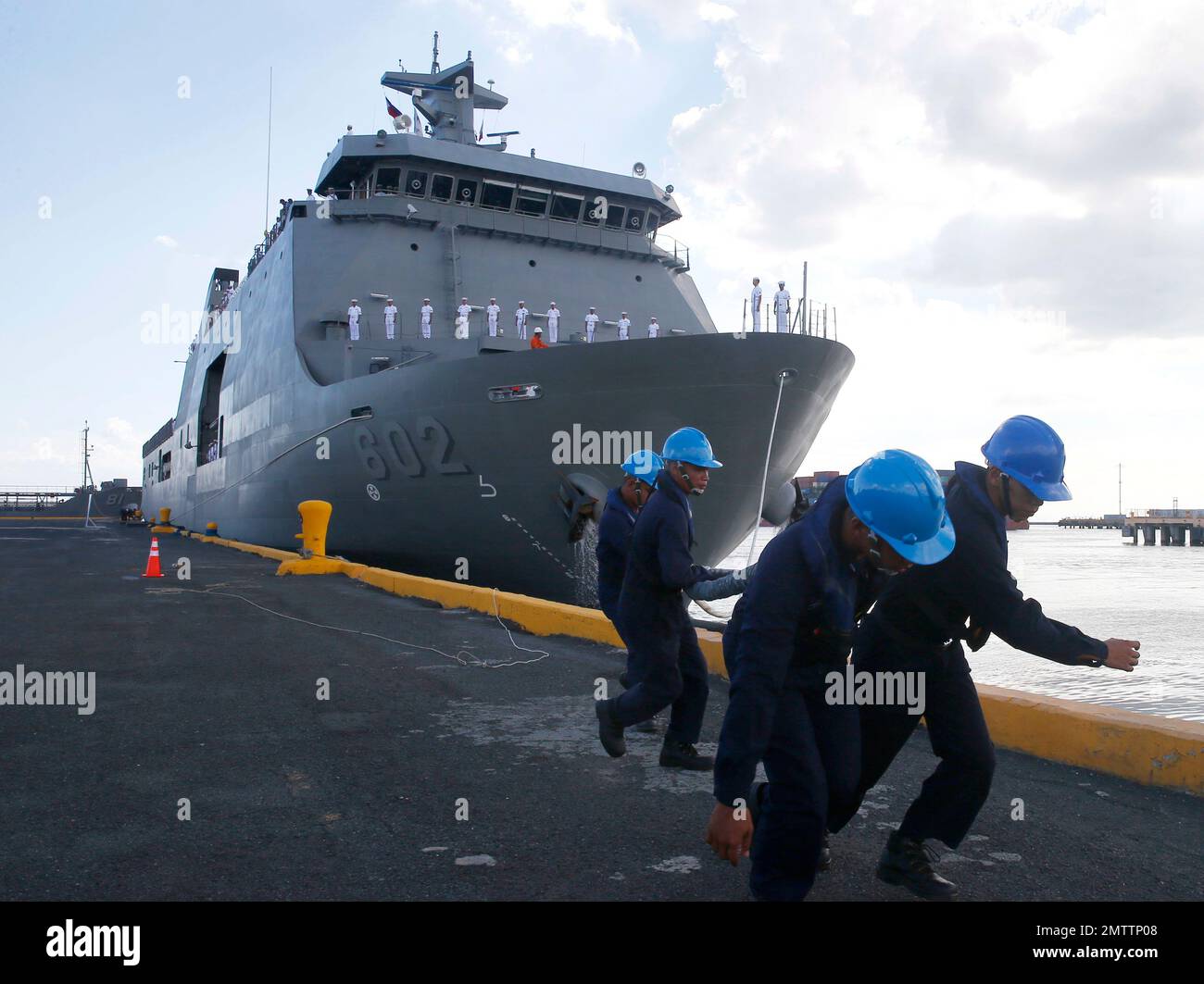 Philippine navy crew pull a rope as its new ship named BRP Davao del ...