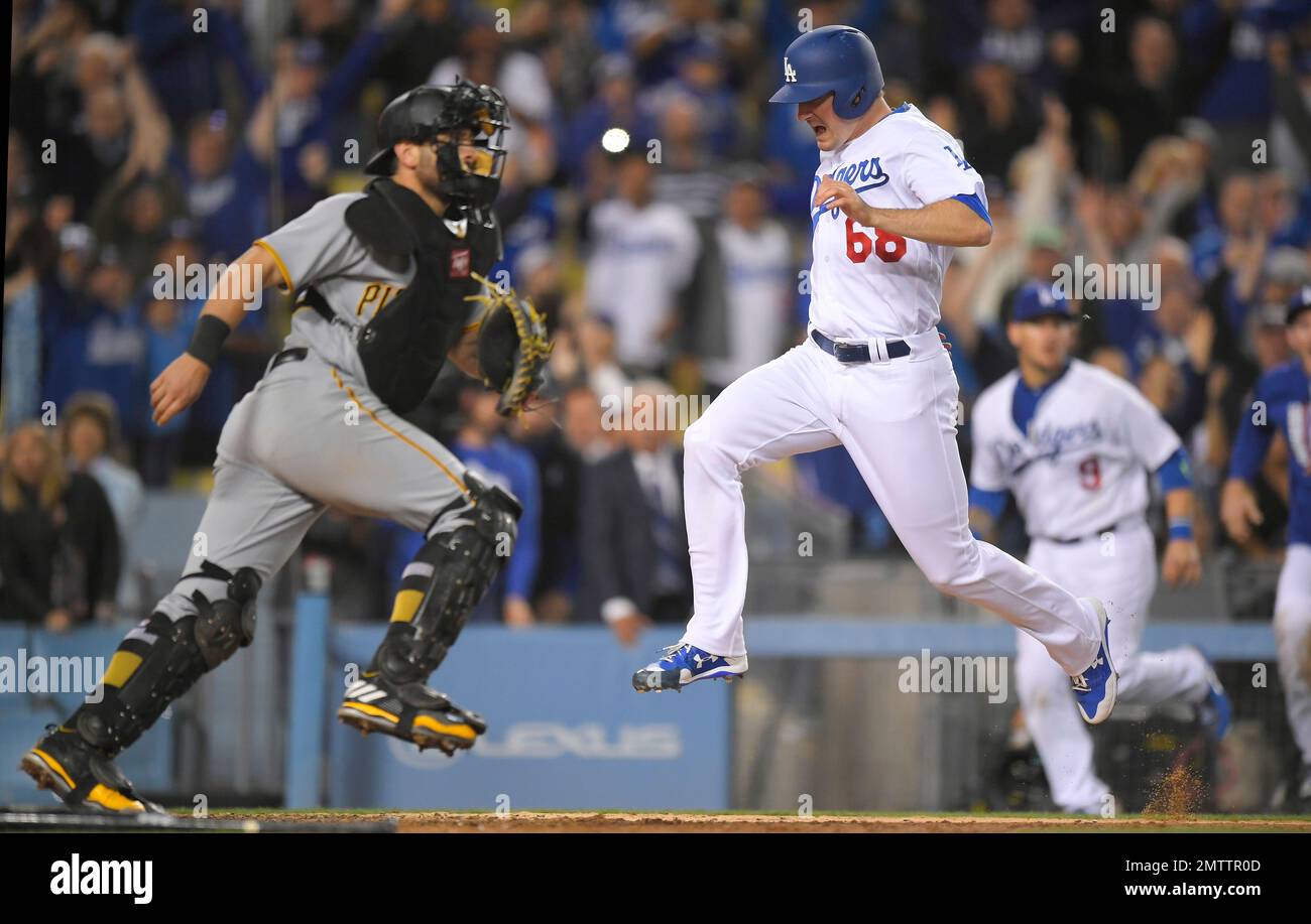 Los Angeles Dodgers' Ross Stripling, right, scores the winning run on a ...