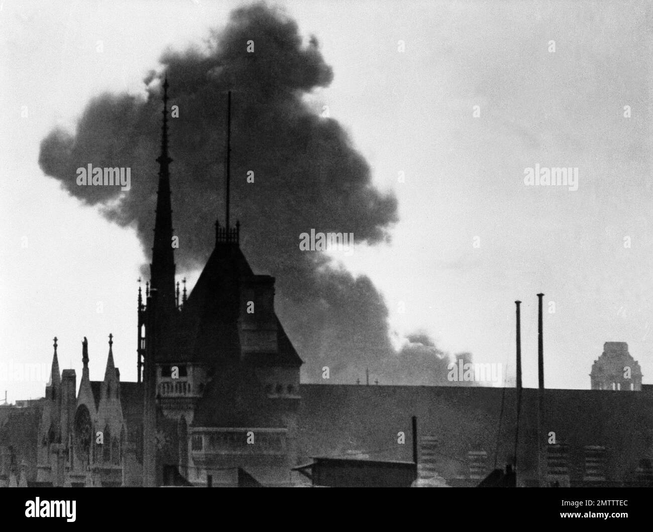 In this view from a Fleet Street rooftop, a cloud of smoke rises after ...