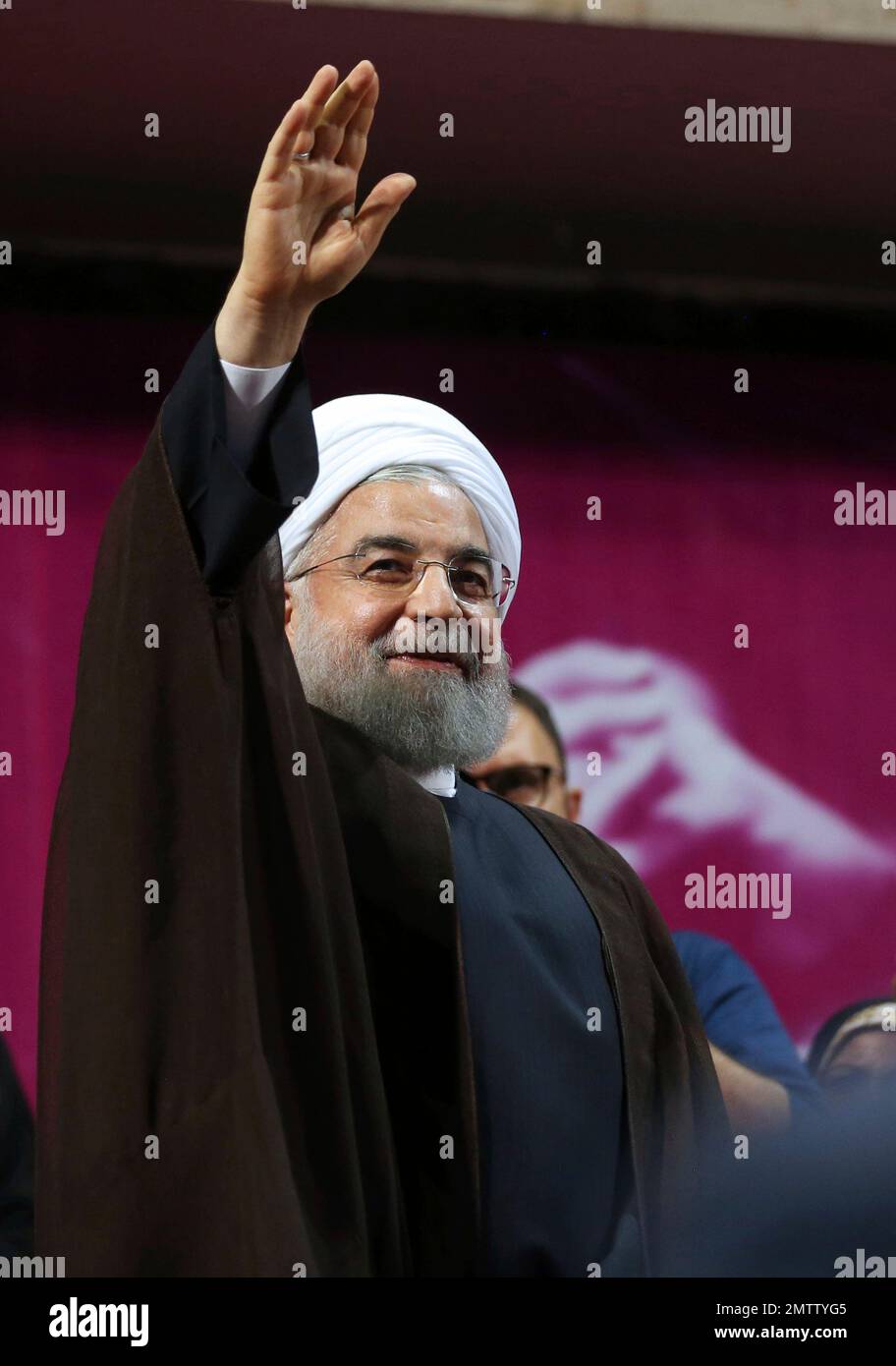 Iranian President Hassan Rouhani waves to his supporters upon arrival ...