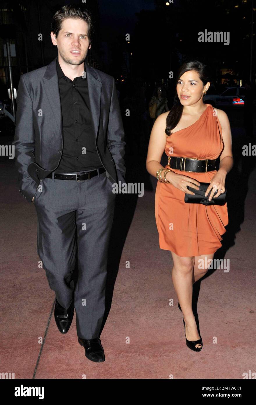 Clad in a flattering orange cocktail dress and wide belt, actress ...