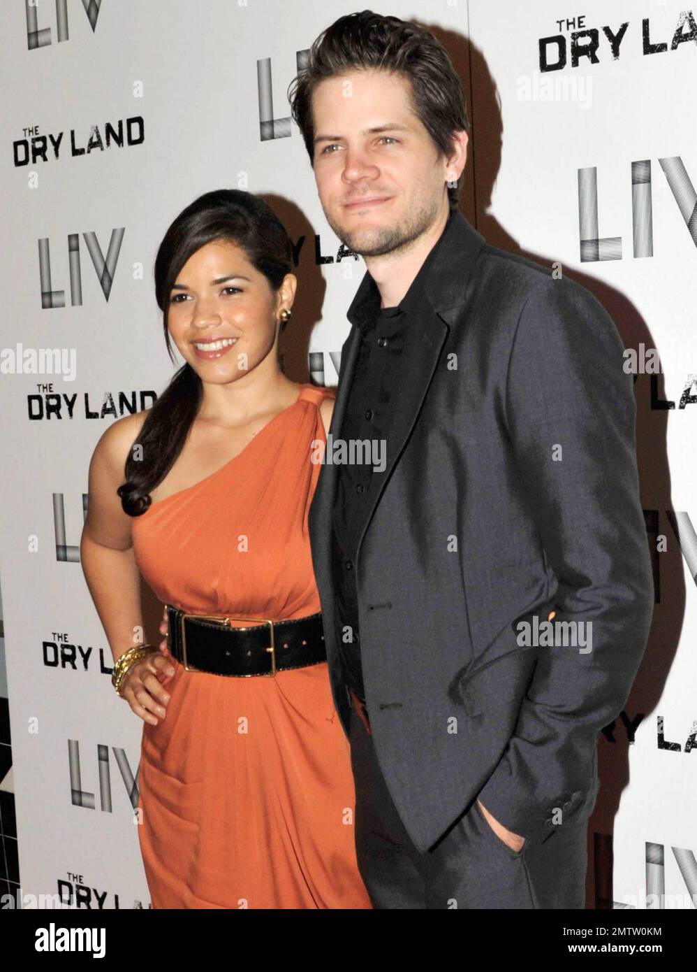 Clad in a flattering orange cocktail dress and wide belt, actress ...