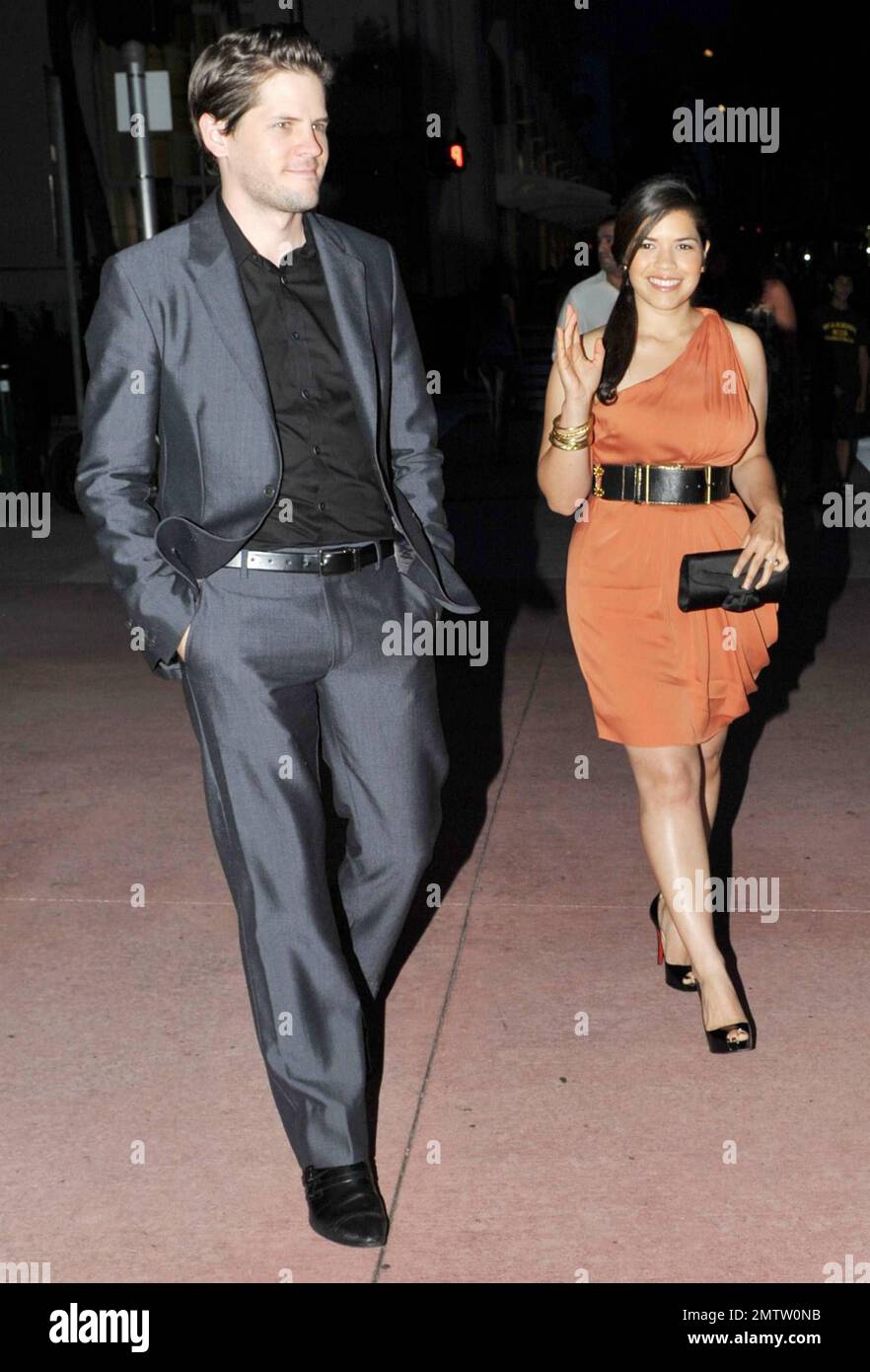 Clad in a flattering orange cocktail dress and wide belt, actress ...