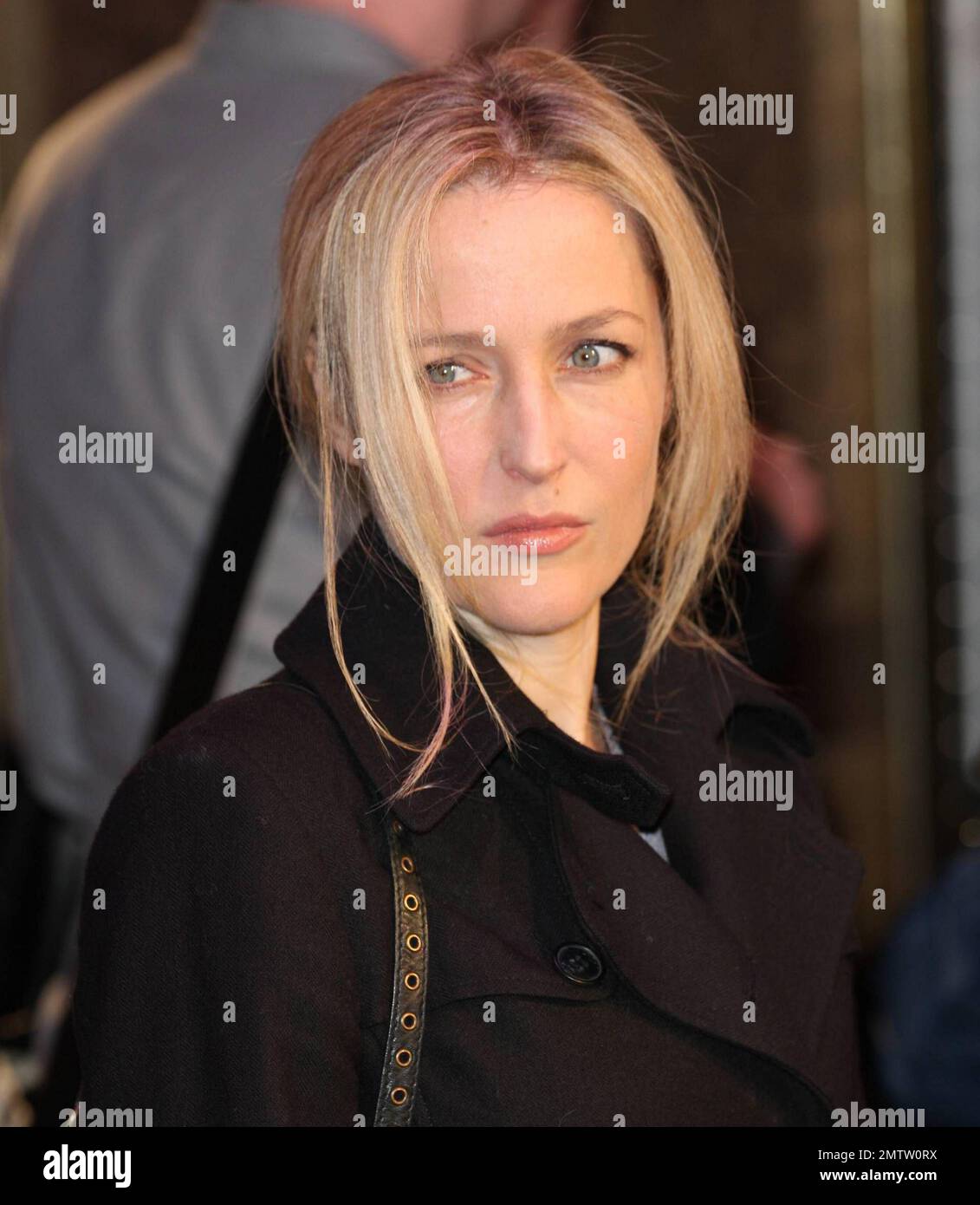 In a unique balloon skirt and black jacket Gillian Anderson poses for ...