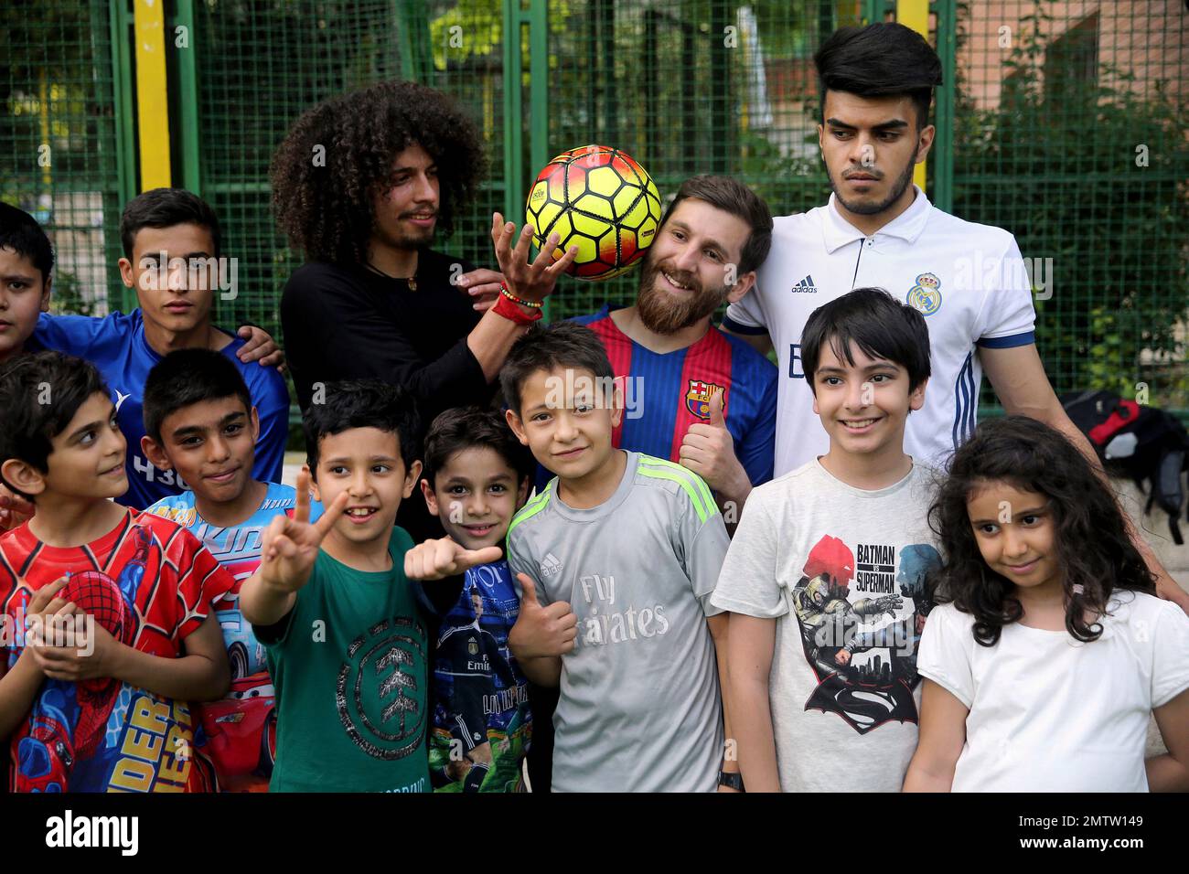 In this May 8, 2017, photo, Iranians take a picture with Reza Parastesh ...
