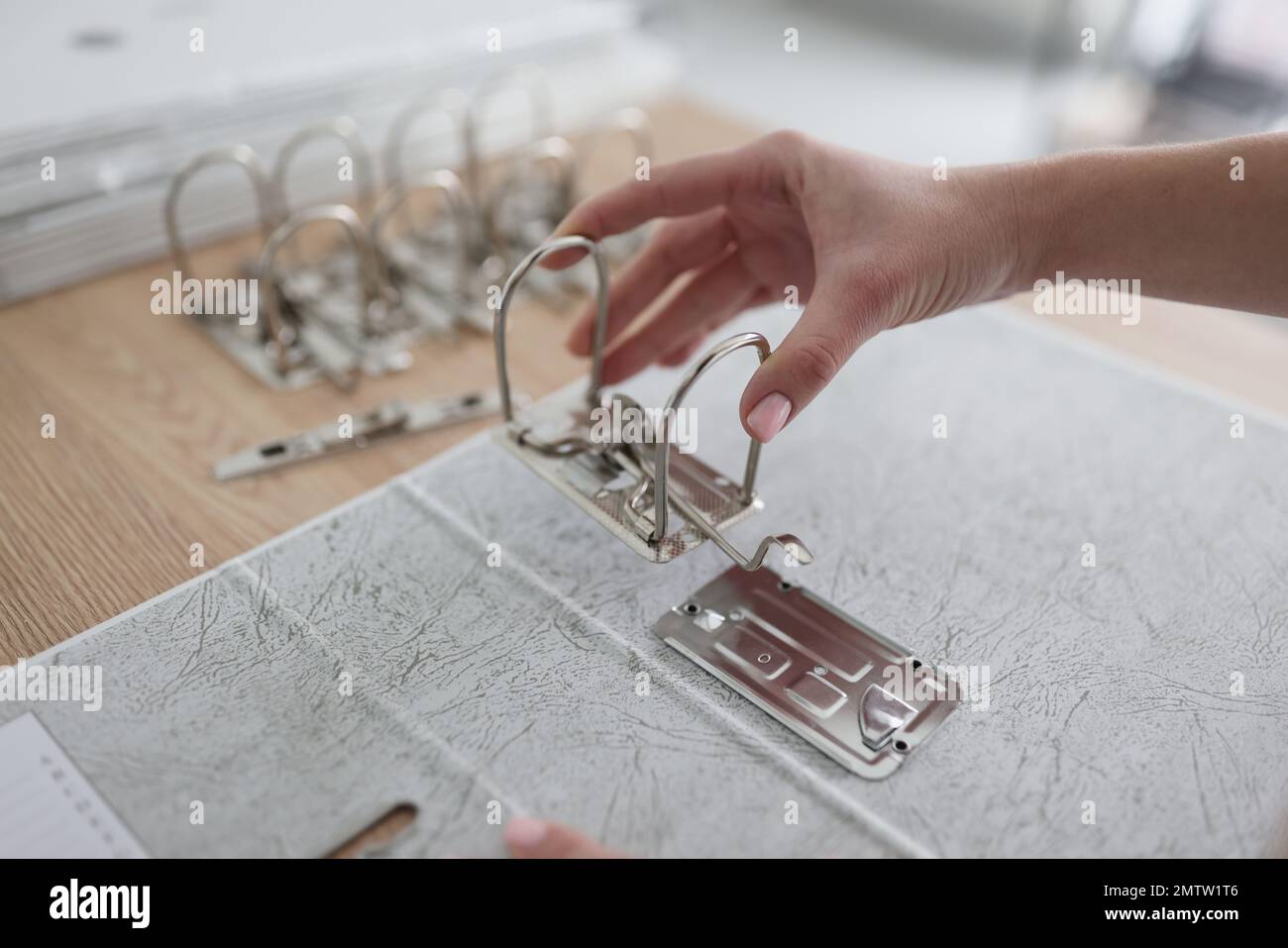 The hand inserts the ring mechanism into the folder Stock Photo - Alamy
