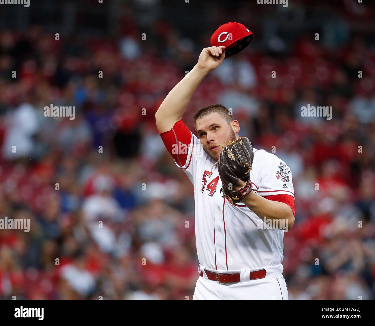 Cincinnati Reds starting pitcher Rookie Davis wipes his forehead in the ...