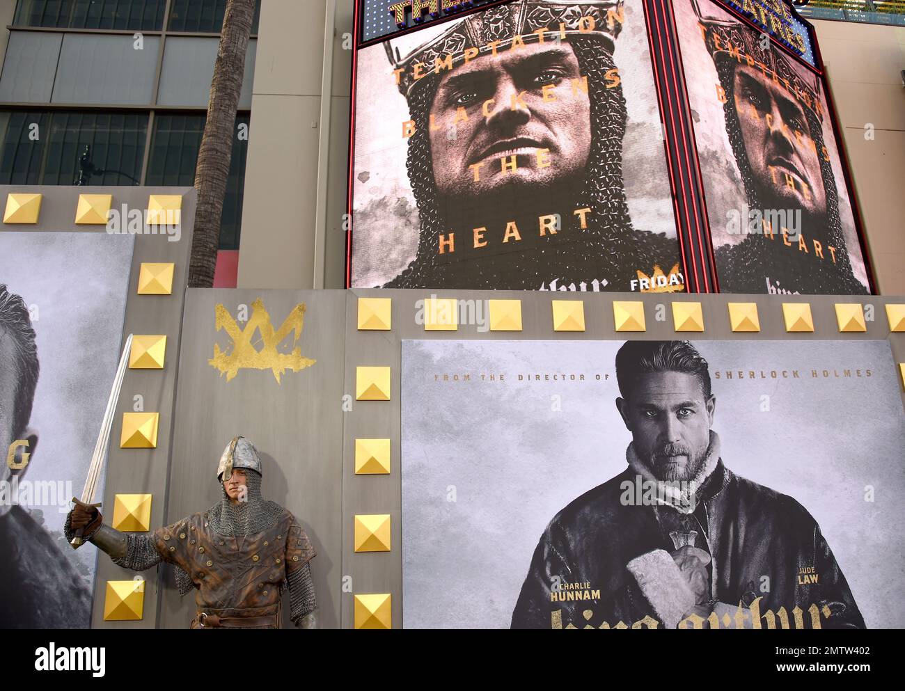 An actor dressed as a knight arrives at the world premiere of "King ...