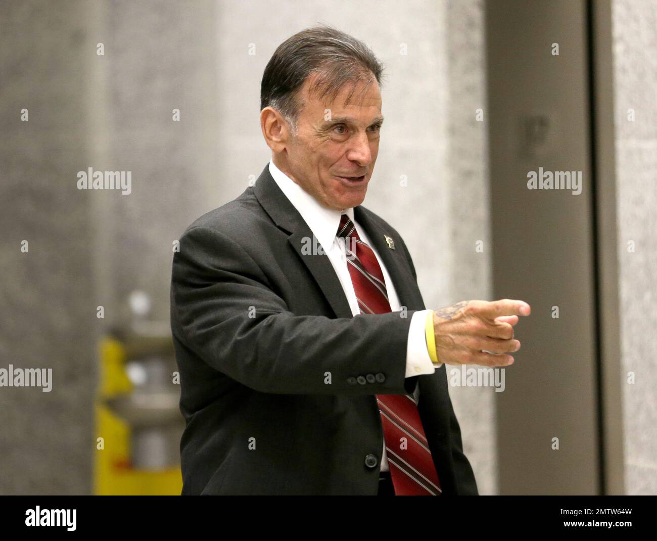 Former Detective Louis Scarcella talks to somone outside the courtroom ...