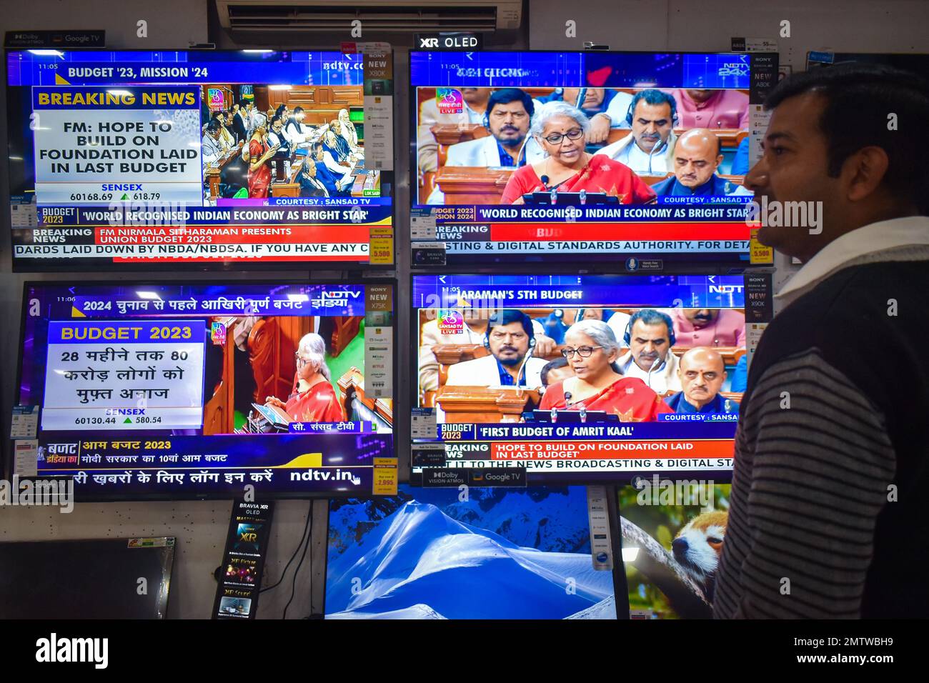 A man seen watching Finance Minister of India Nirmala Sitharam announce ...