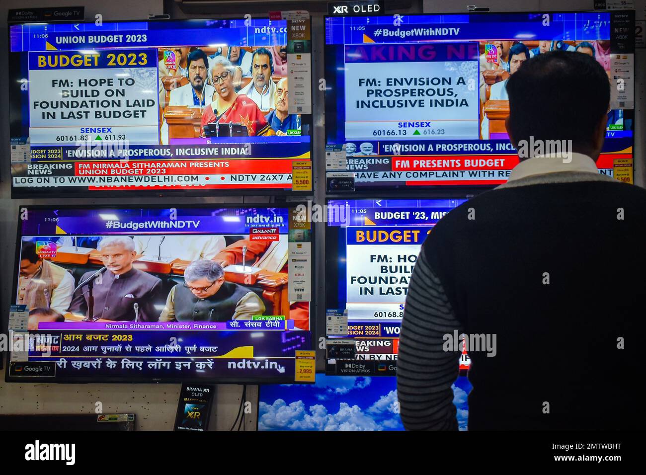 A man seen watching Finance Minister of India Nirmala Sitharam announce ...