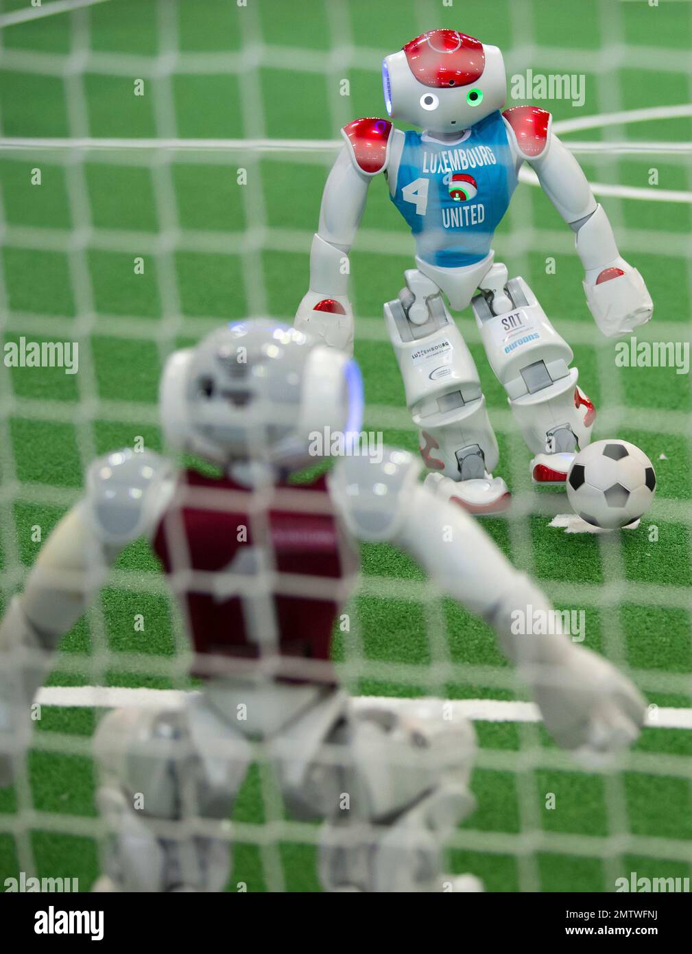 A robot of the Luxenbourg team, right, scores a goal past the ...