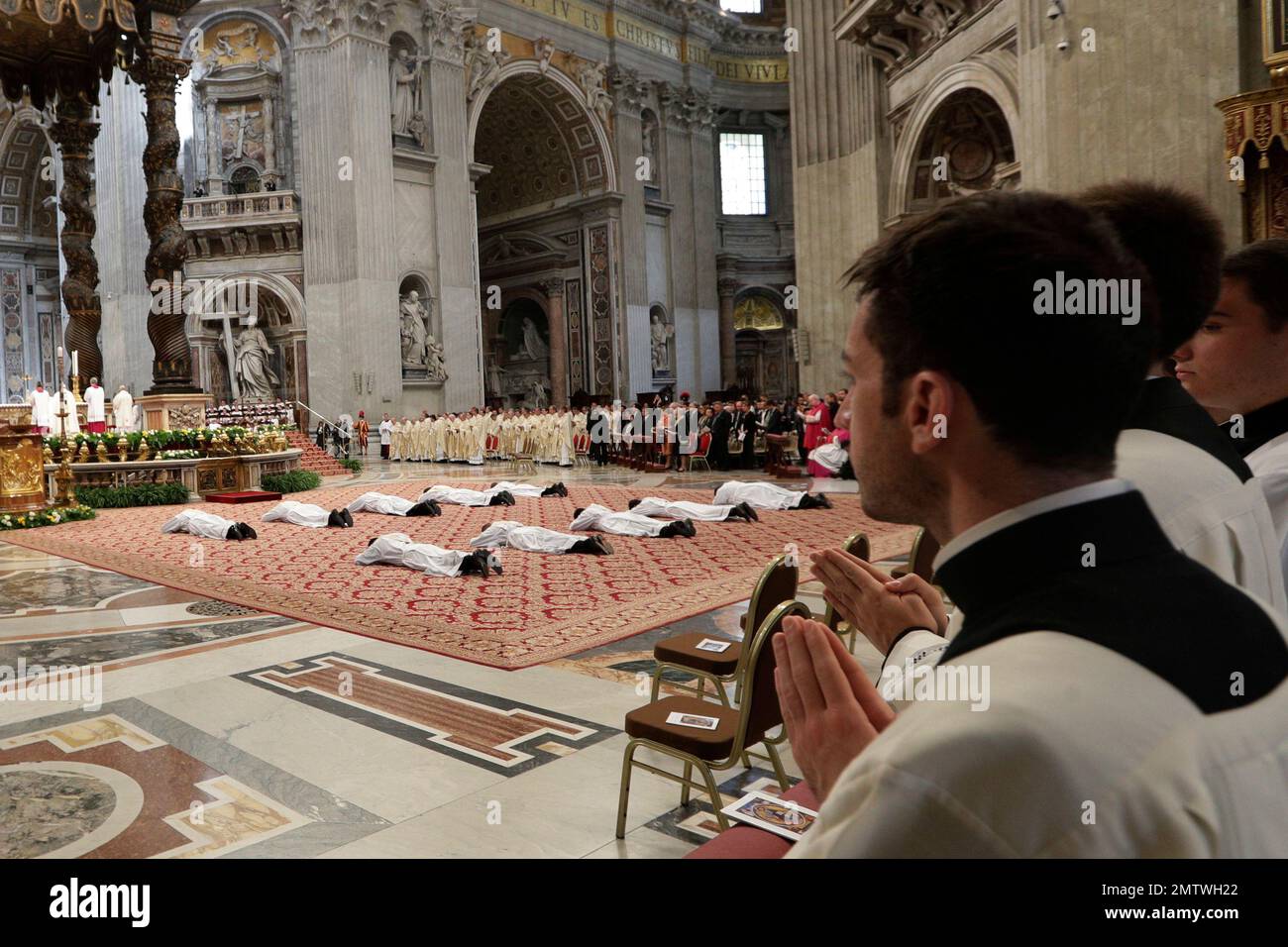 Ten new priests that were ordained by Pope Francis lay on the ground ...