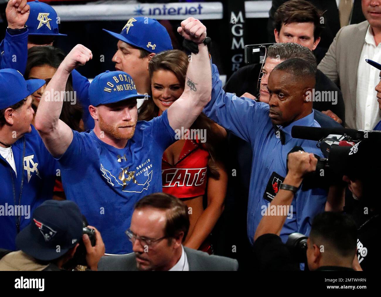 Referee Kenny Bayless, right, raises the arm of Canelo Alvarez, of ...