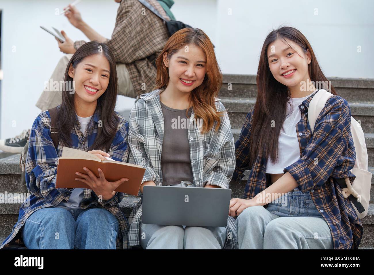 Beautiful young Asian woman college student with friends at outdoors ...