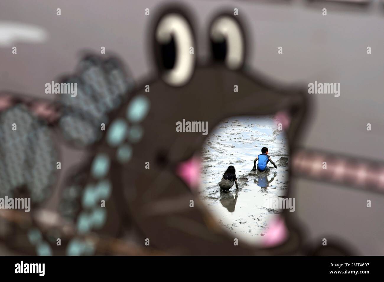 Visitors play at in the tidal mud flats of Tideland on the Ariake sea ...