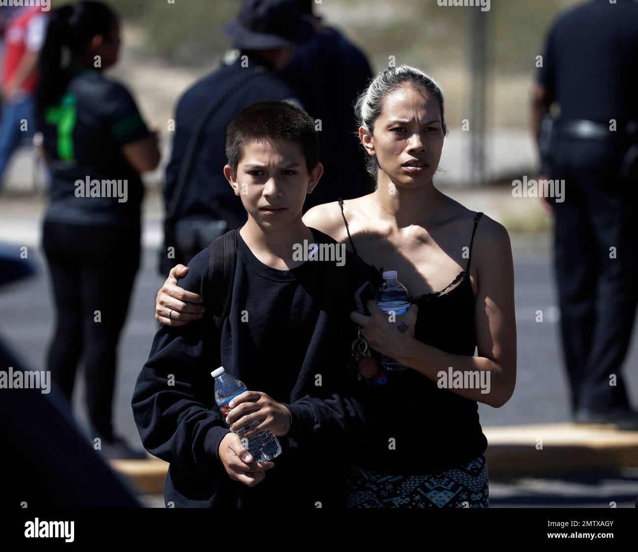 Christina Marquez, right, picks up her son Angelo Marquez at the scene ...