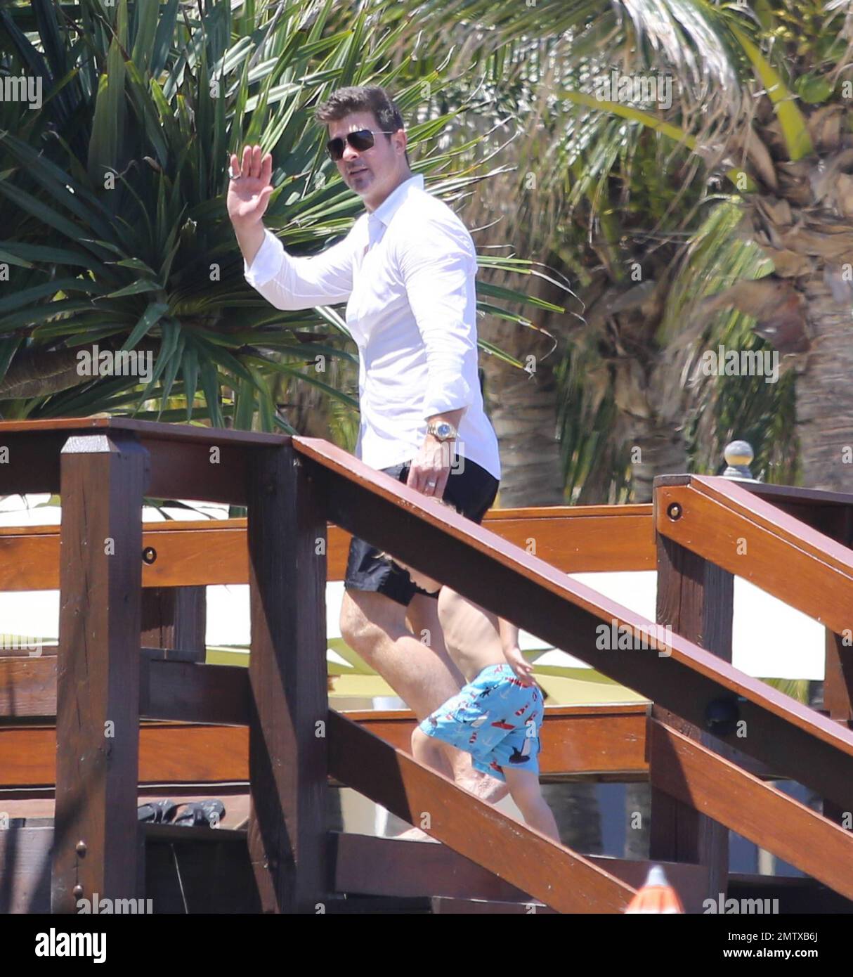 Robin Thicke and wife Paula Patton come down to collect their son ...