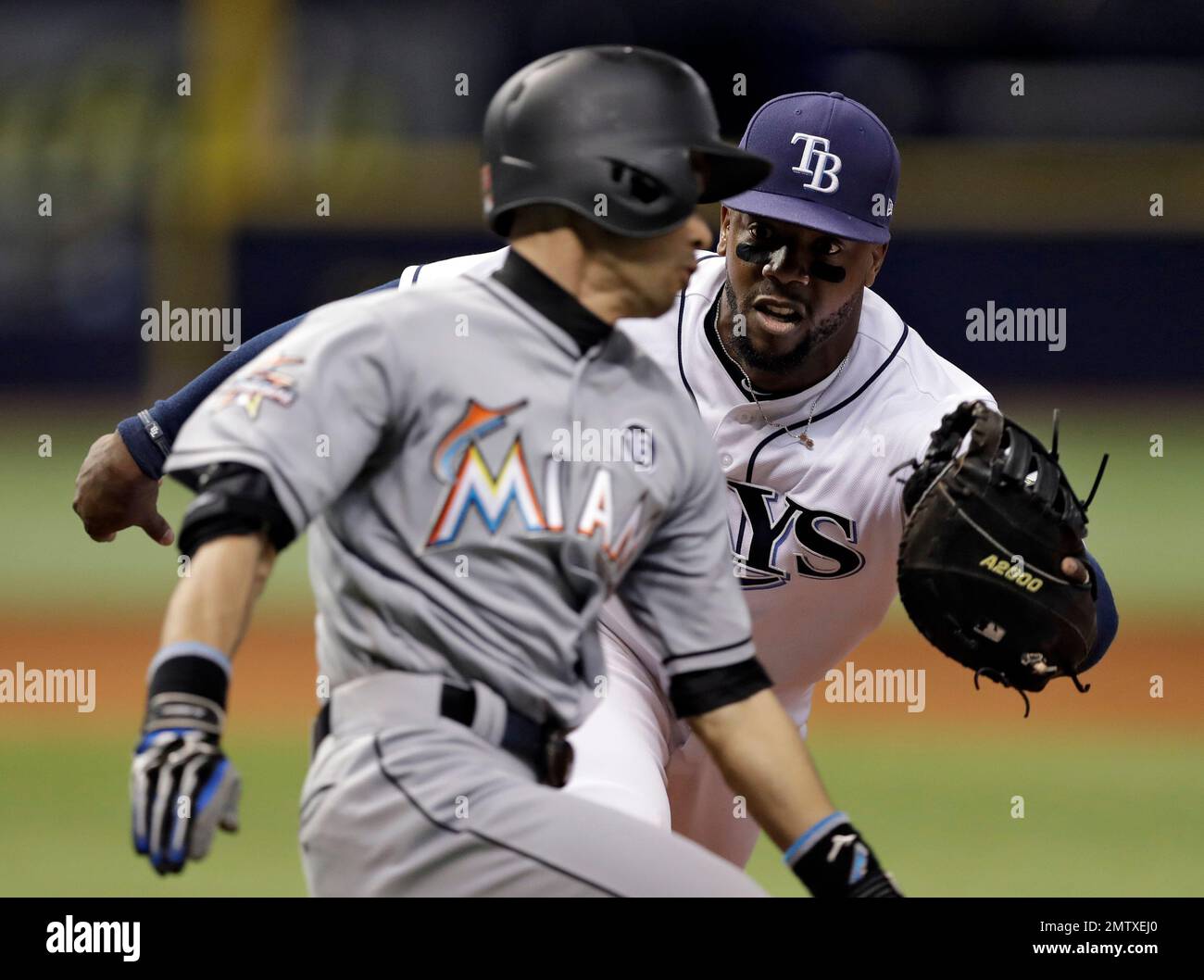 Tampa Bay Rays first baseman Rickie Weeks Jr., background, tags out ...