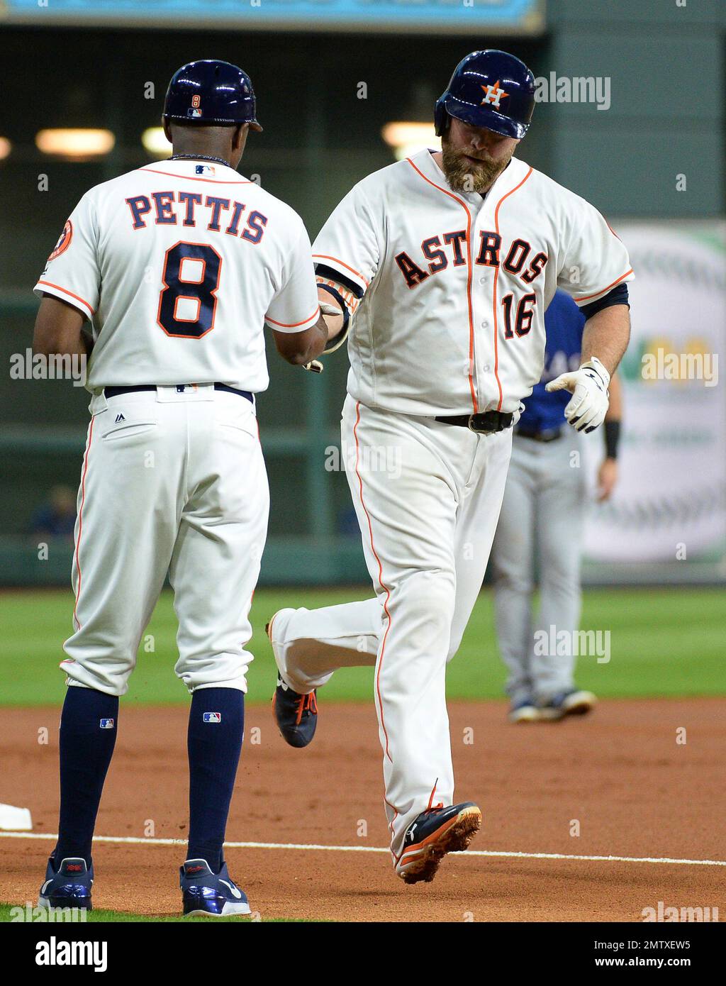Houston Astros' Brian McCann (16) is congratulated by third base coach ...