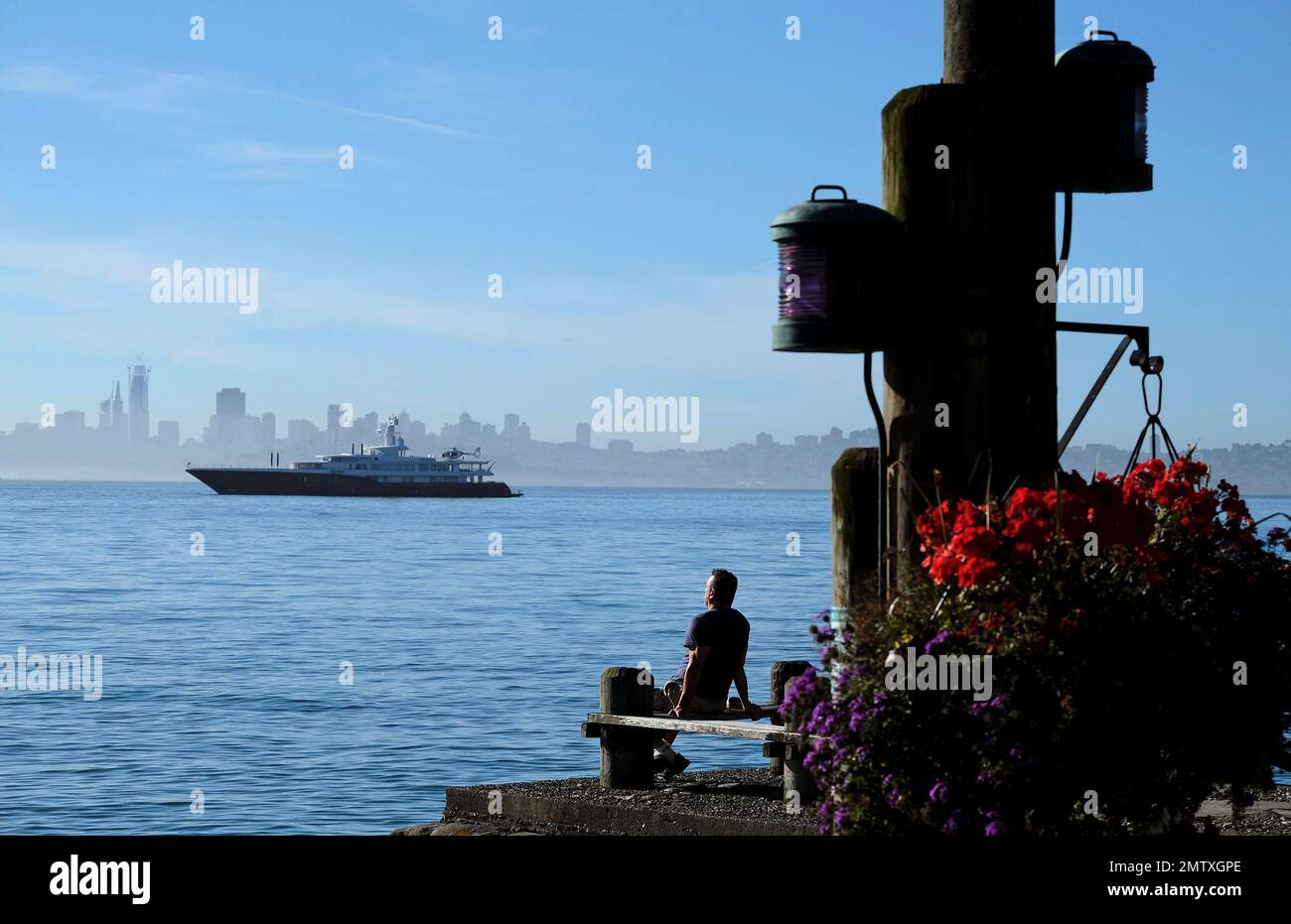 A man catches the morning sun with the 266-foot luxury yacht Air and ...