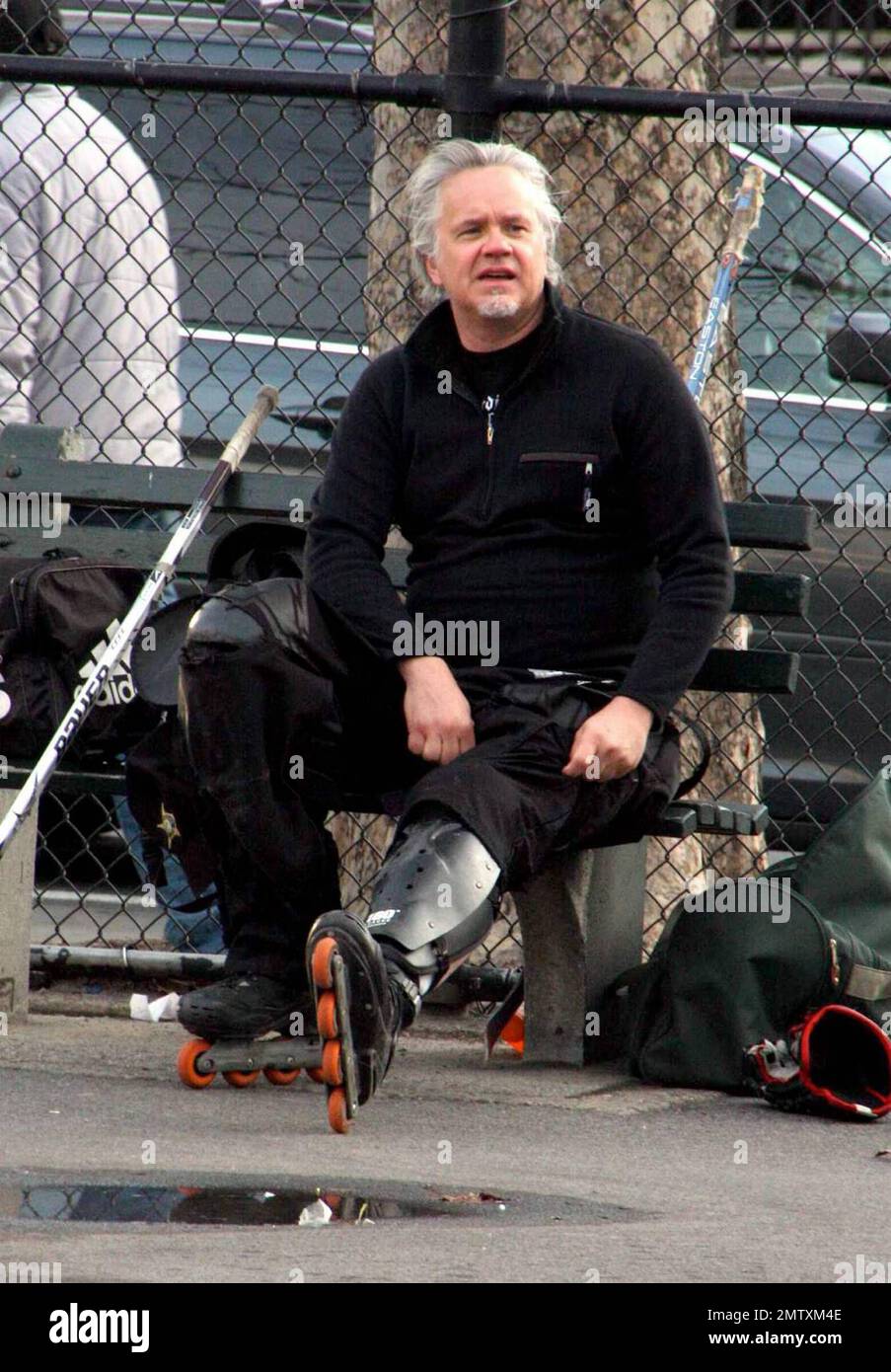 Actor Tim Robbins gets in a game of roller hockey with a group of ...