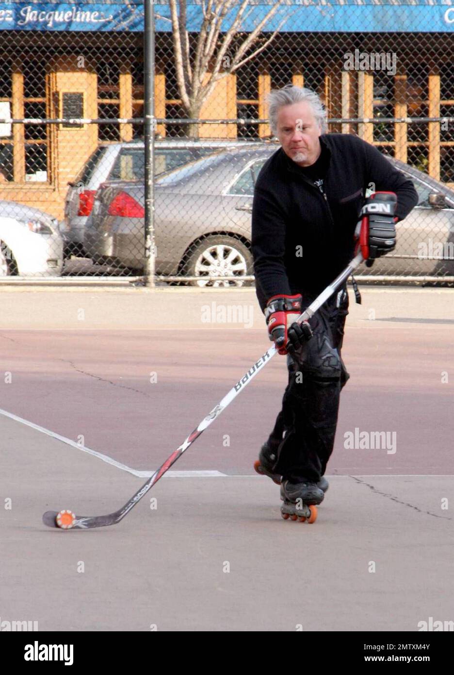 Actor Tim Robbins gets in a game of roller hockey with a group of ...