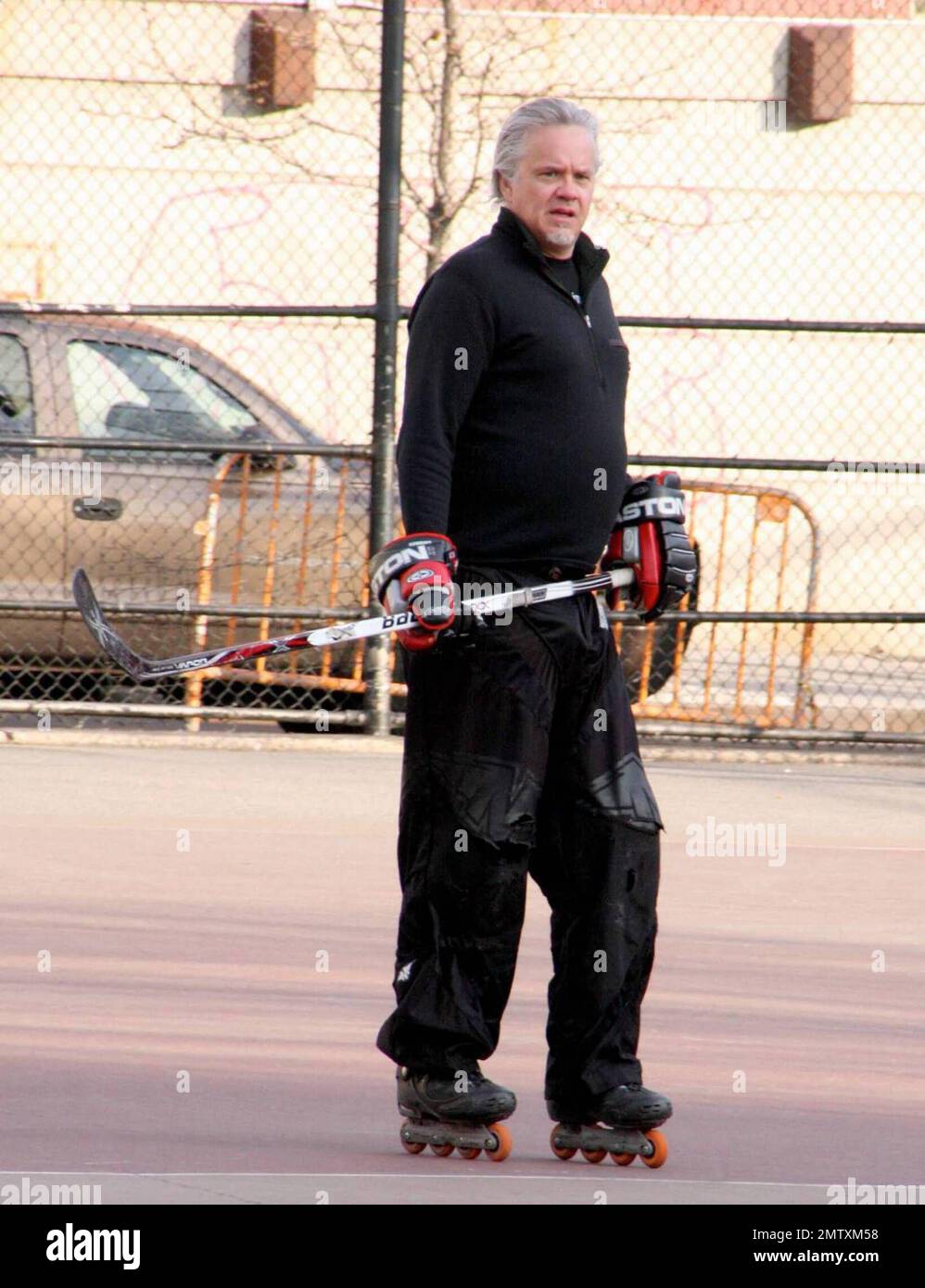 Actor Tim Robbins gets in a game of roller hockey with a group of ...