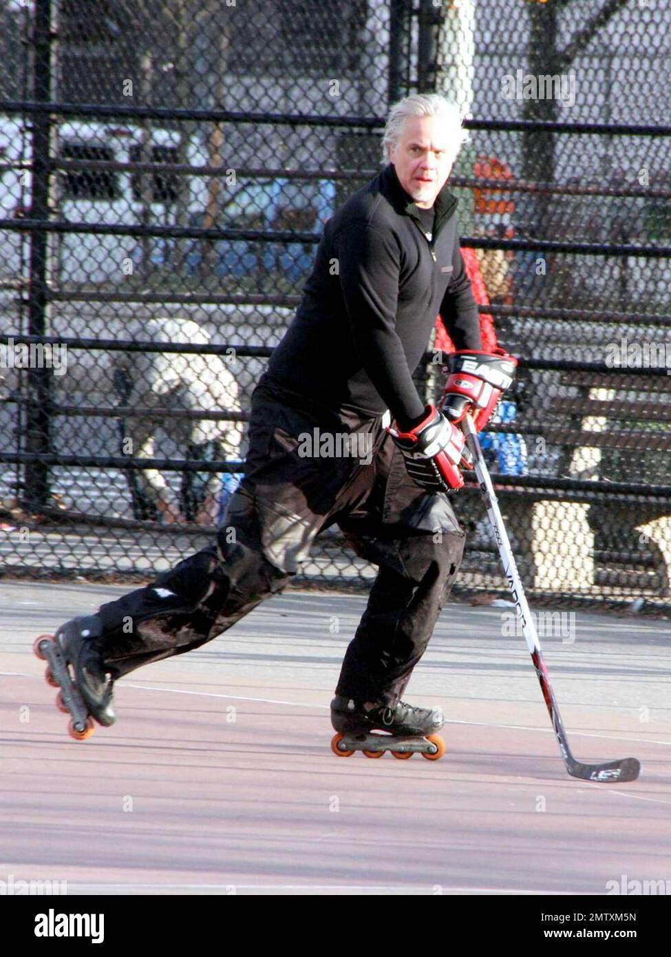 Actor Tim Robbins gets in a game of roller hockey with a group of ...