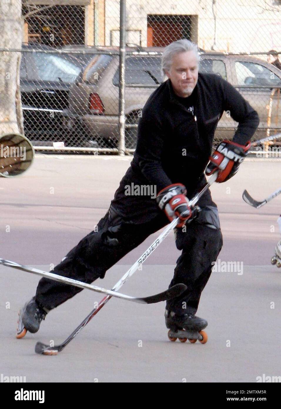 Actor Tim Robbins gets in a game of roller hockey with a group of ...