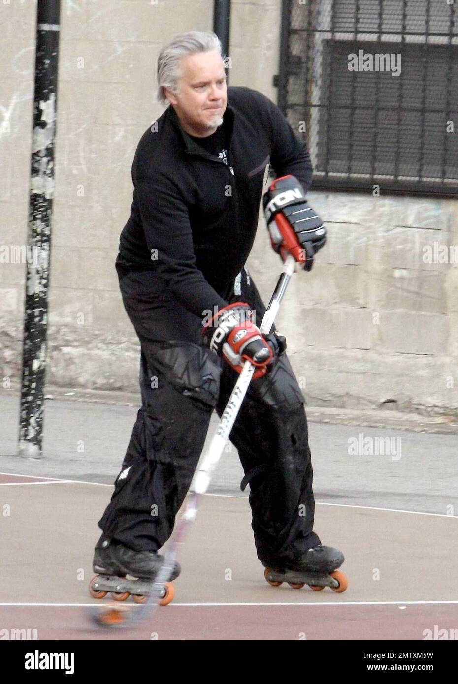 Actor Tim Robbins gets in a game of roller hockey with a group of ...