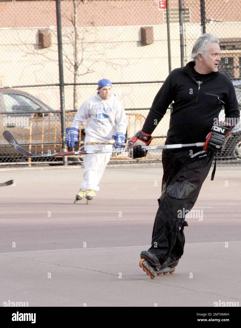 Actor Tim Robbins gets in a game of roller hockey with a group of ...
