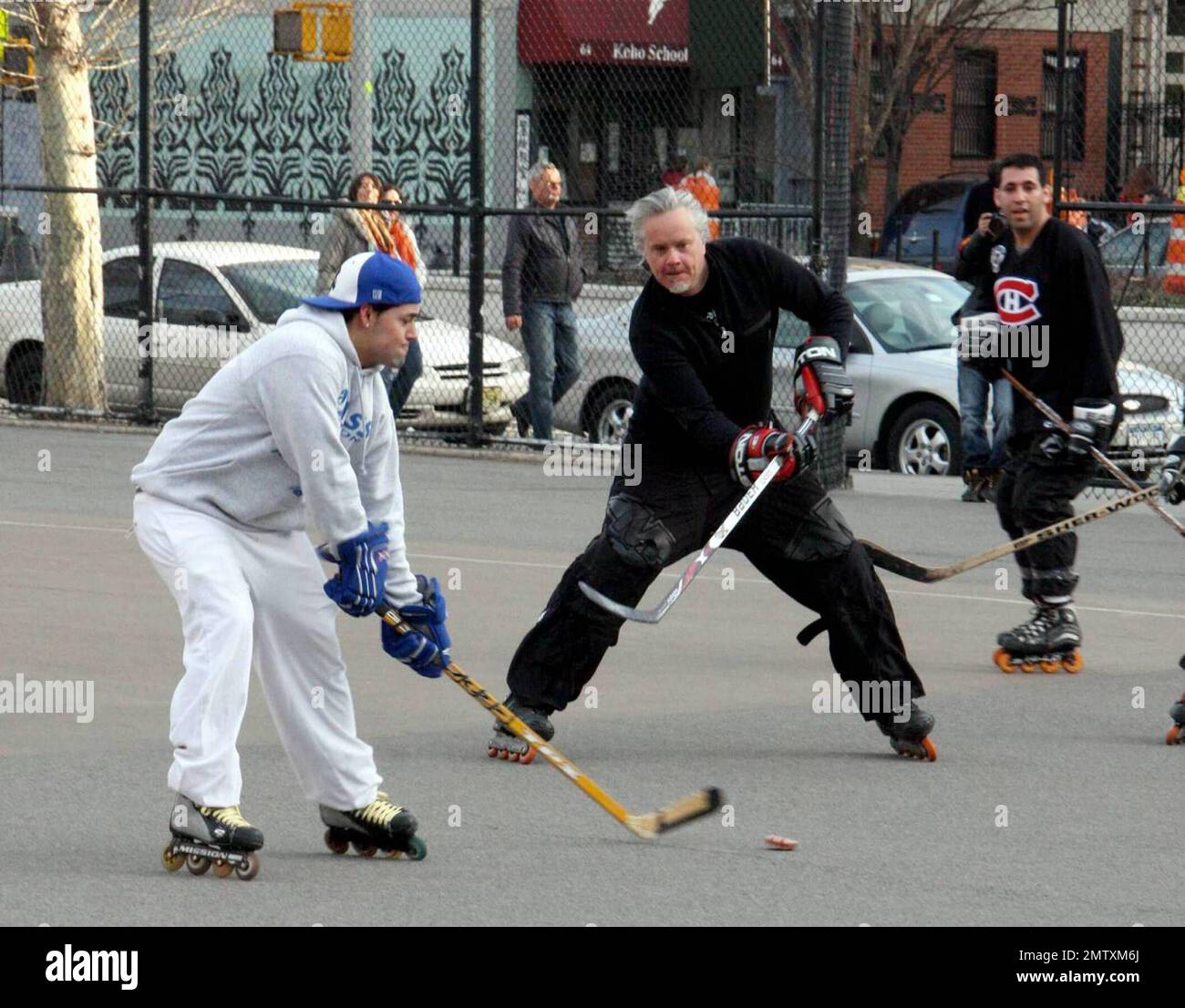 Actor Tim Robbins gets in a game of roller hockey with a group of ...