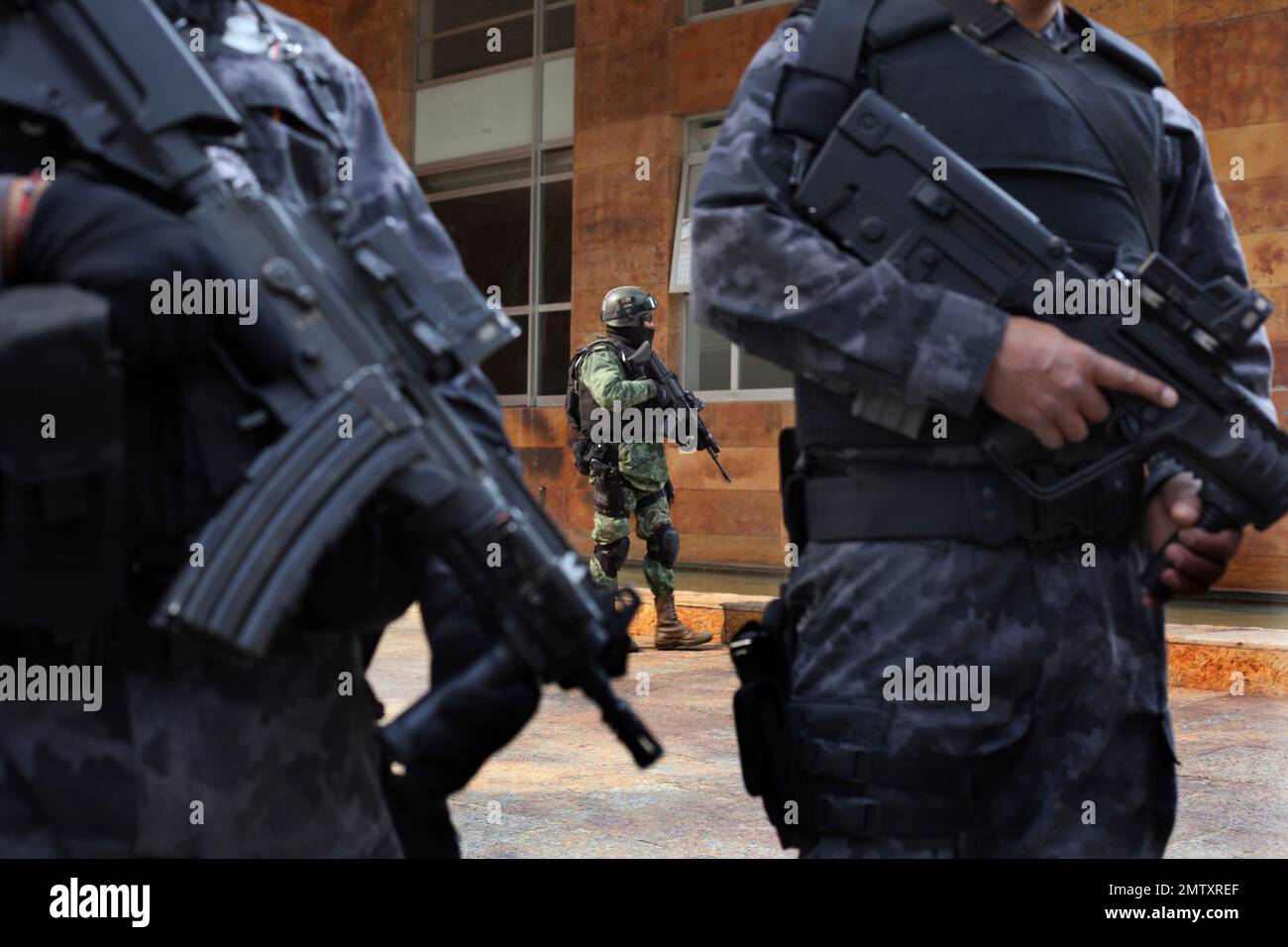 Security agents stand guard outside the apartment building where Damaso ...