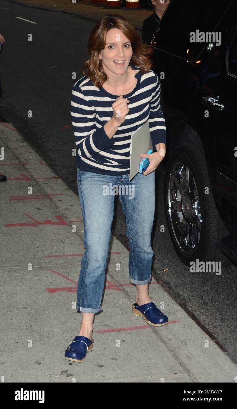 Wearing a striped shirt, jeans and blue clogs, Tina Fey arrives at the ...