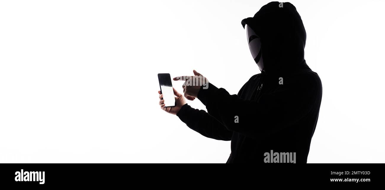 Hacker Anonymous and face mask with smartphone in hand. Man in black ...