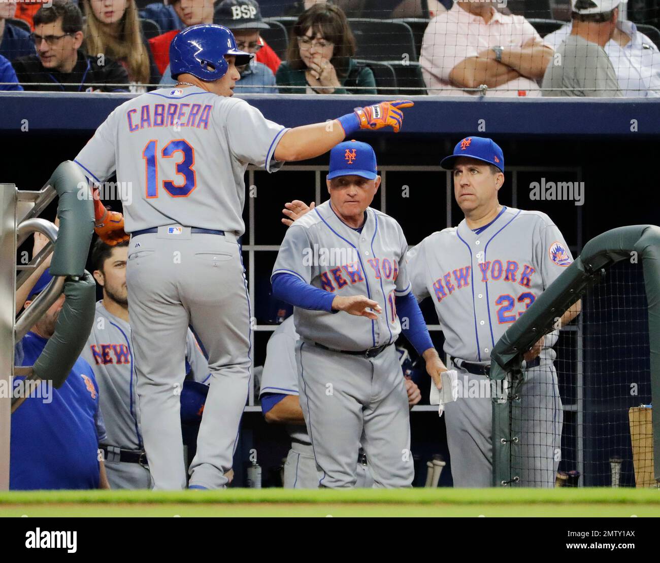 New York Mets' Asdrubal Cabrera, left, gestures after scoring off a ...